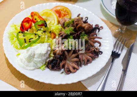 Mini calamari with vegetable salad and sauce on white plate Stock Photo ...