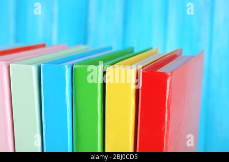 Colorful books on turquoise wooden background Stock Photo - Alamy