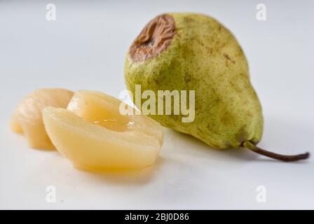 Comparison of fresh, raw pear, starting to rot with canned pears ...