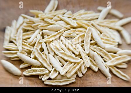 Raw cicatelli pasta shapes on wooden surface Stock Photo - Alamy