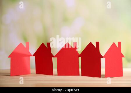 Paper houses on bright background Stock Photo - Alamy
