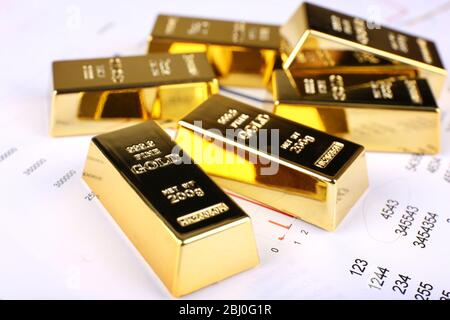 Gold bullion on documents background Stock Photo - Alamy