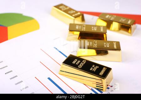 Gold bullion on documents background Stock Photo - Alamy