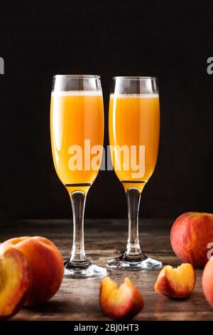 Peach cocktail in glass on light table Stock Photo - Alamy