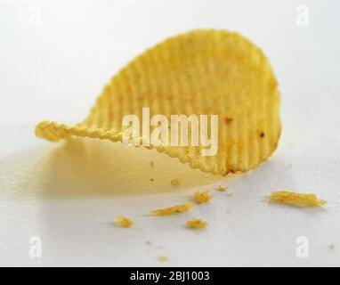 Single potato crisp on a white background Stock Photo - Alamy