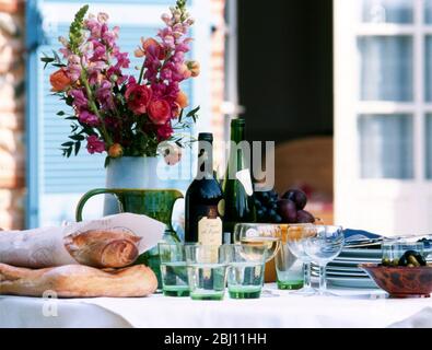 Table set outside for light summer lunch Stock Photo - Alamy