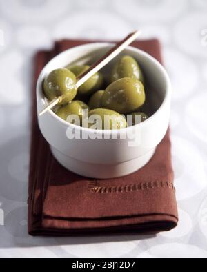 Green olive on toothpick Stock Photo - Alamy