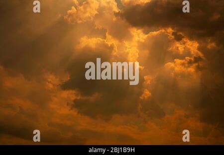 God light. Dramatic golden cloudy sky with sun beam. Yellow sun rays ...