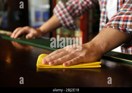 Bartender wiping down bar counter Stock Photo - Alamy