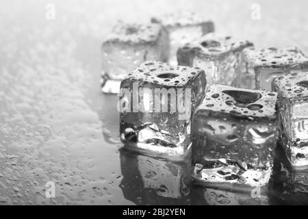 Melting ice cubes with drops around, close up Stock Photo - Alamy