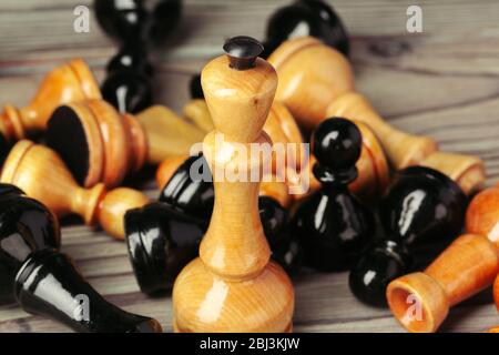 chess figures on brown woden table background Stock Photo - Alamy