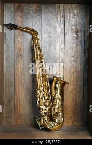 Beautiful golden saxophone on wooden background Stock Photo - Alamy