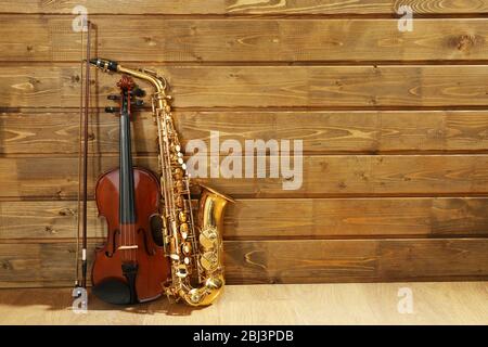Violin and saxophone on wooden background Stock Photo - Alamy