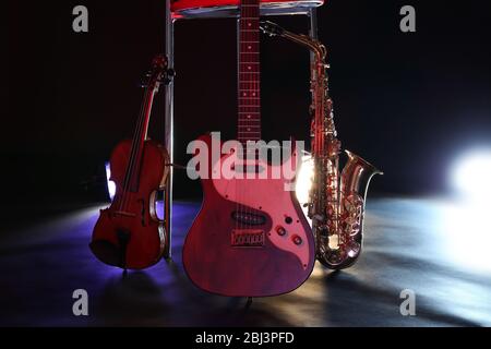 Beautiful golden saxophone and guitar near bar stool on a scene Stock ...