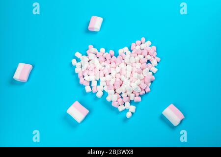 Colorful marshmallow laid out on pink paper background. pastel creative ...