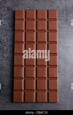 Chocolate bar on dark grey background Stock Photo - Alamy