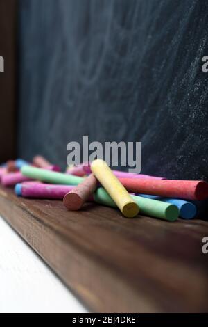 Many chalks on desk background Stock Photo - Alamy