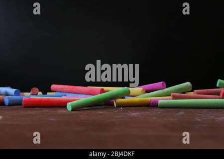 Many chalks on desk background Stock Photo - Alamy