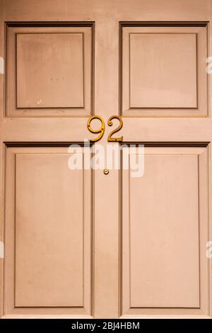 House number 92 in thin elegant metal digits on a traditional panelled ...