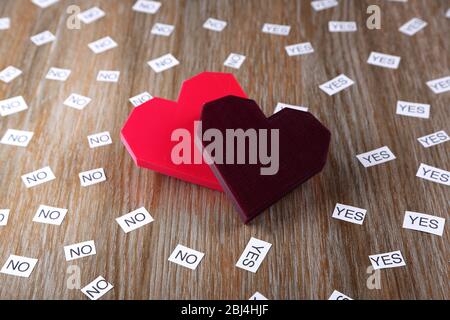 Two red hearts with yes and no on wooden background Stock Photo - Alamy
