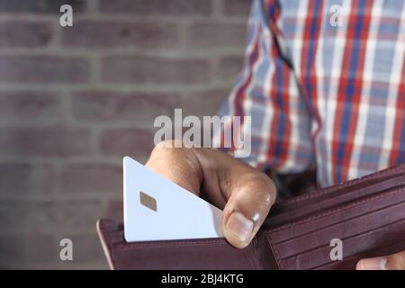 Man taking credit card from wallet in bedroom, closeup Stock Photo - Alamy
