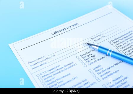 Laboratory test list with pen on blue background, close up Stock Photo ...