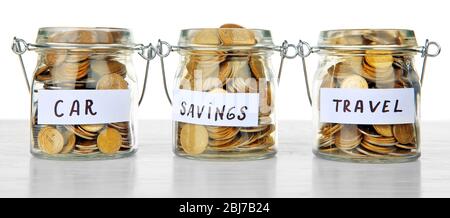 Three jars for different needs full of banknotes Stock Photo - Alamy