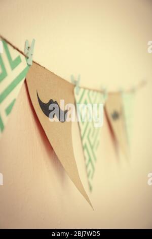 Triangle garland with mustache and pattern on wall Stock Photo - Alamy