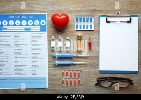 Doctor table with medicines, clipboard and red heart, top view Stock ...
