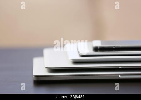 Stack of electronic devices on a dark desk Stock Photo - Alamy