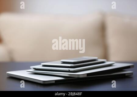 Stack of electronic devices on a dark desk Stock Photo - Alamy