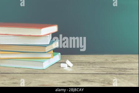 Few books with chalk on table Stock Photo - Alamy