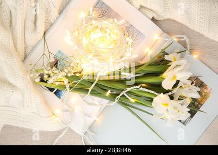 Beautiful fresh iris flowers with garland and album, top view Stock ...