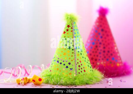 Party hats on bright background Stock Photo - Alamy