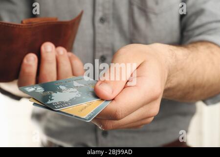 Male hands with wallet and credit cards at home, closeup Stock Photo ...