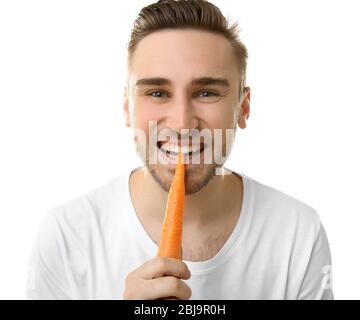Handsome man eating carrot, isolated on white Stock Photo - Alamy