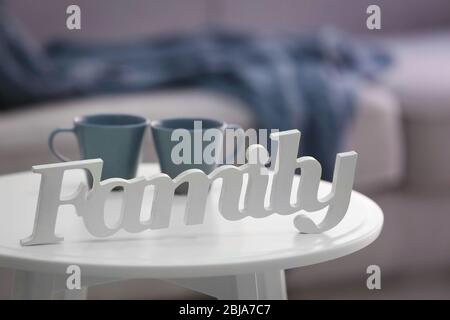 Word Family and cups on coffee table Stock Photo - Alamy