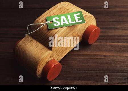 Sale label on wooden toy car Stock Photo - Alamy