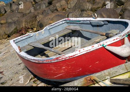 Red and white painted rowing boat at the beach at Isla Maiquillahue in ...