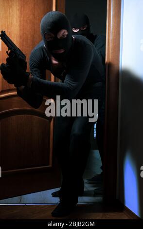 Armed thieves entering a house Stock Photo - Alamy