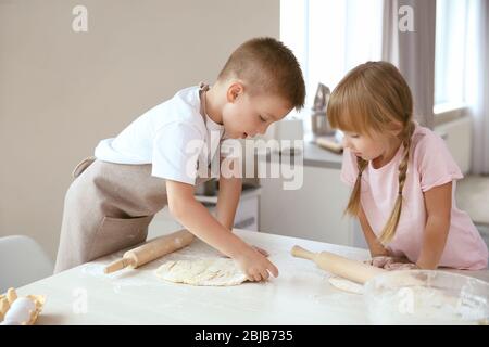 Kids making biscuits in kitchen Stock Photo - Alamy