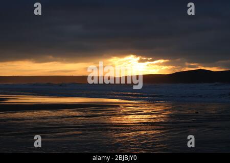 Cloudy Winter Sunset over Polzeath Beach, Cornwall, UK Stock Photo - Alamy