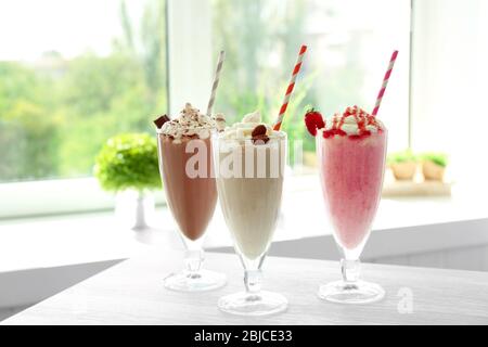 Delicious milkshakes on table in kitchen Stock Photo - Alamy