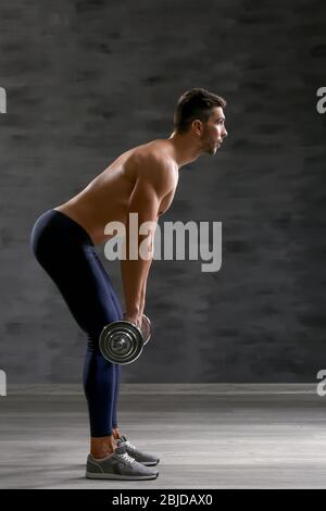 Sporty man doing exercises with barbell on dark background Stock Photo ...