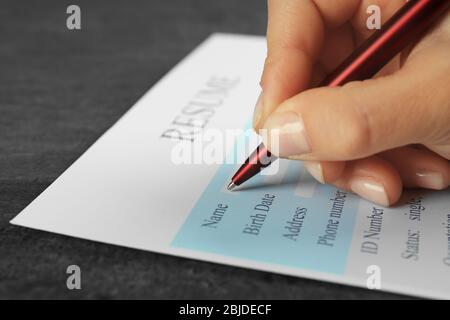 Woman filling in resume form at table. Job interview concept Stock ...
