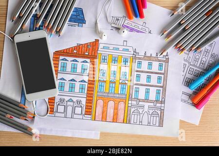 Composition of colouring pictures and pencils, closeup Stock Photo - Alamy
