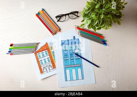 Composition of colouring pictures and pencils on wooden table Stock ...