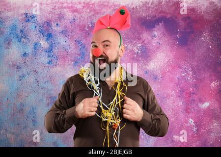 Funny fat man with party decor on color background Stock Photo - Alamy