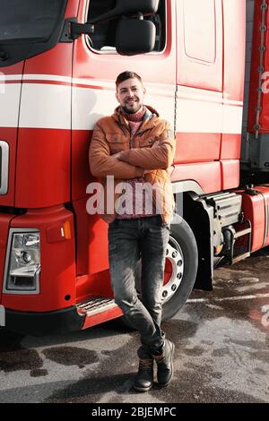 Handsome driver near big modern truck outdoors Stock Photo - Alamy