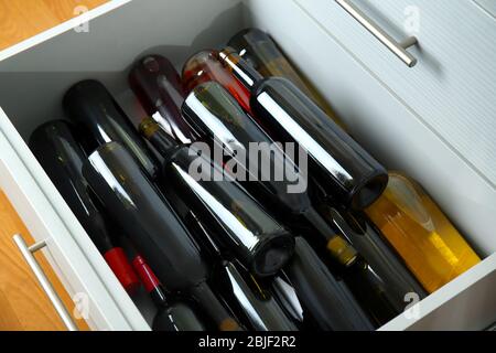 Kitchen drawer with assortment of wine bottles, closeup Stock Photo - Alamy